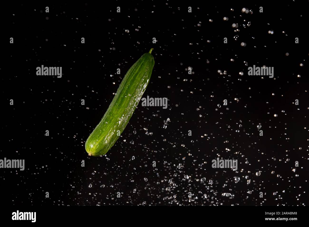 Sliced cucumber with splashing water or explosion flying in the air ...