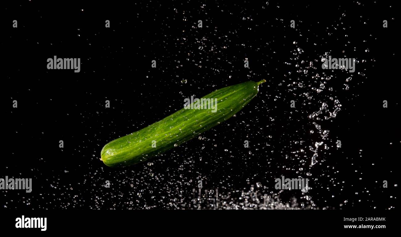 Sliced cucumber with splashing water or explosion flying in the air ...