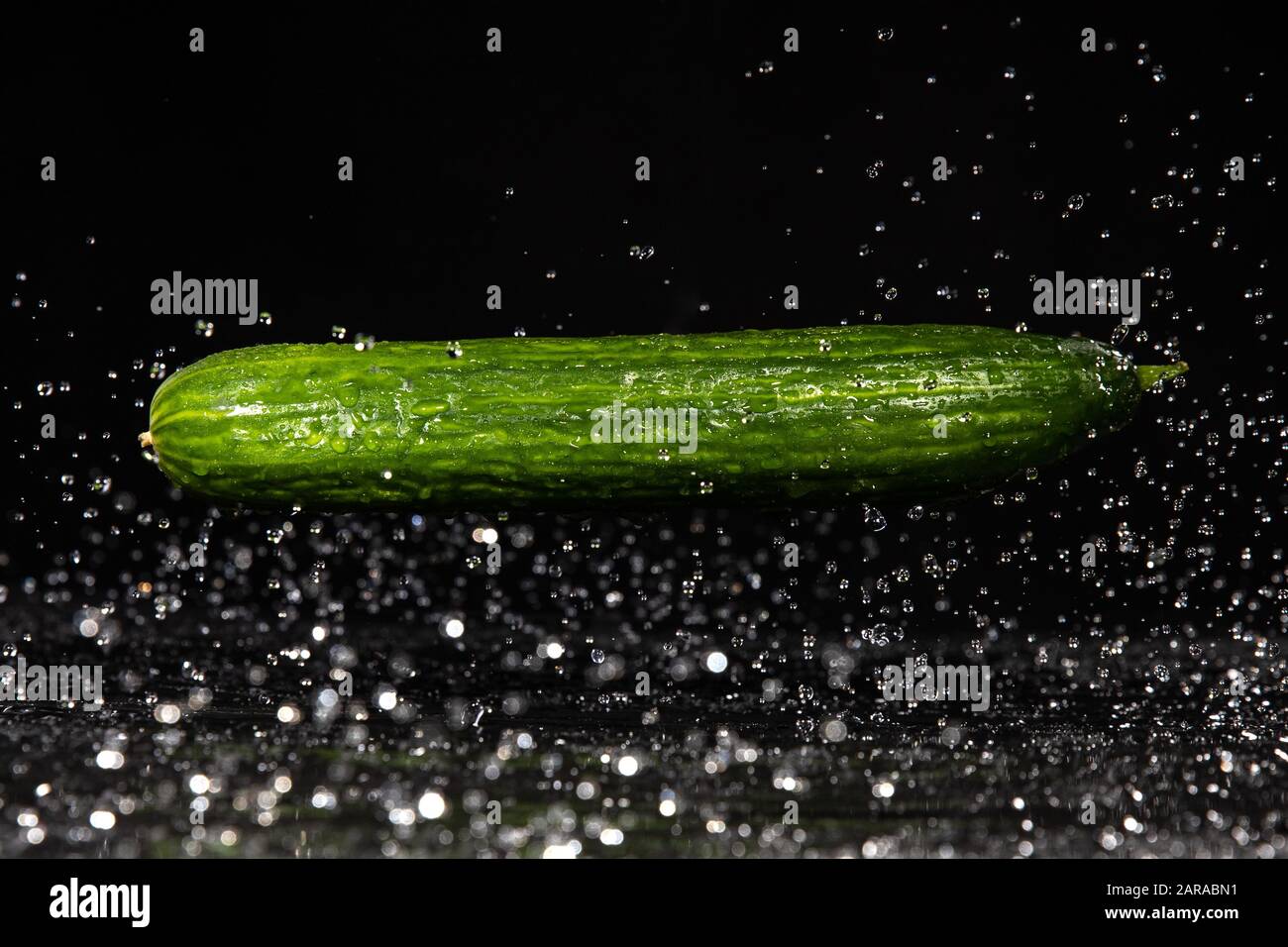 Sliced cucumber with splashing water or explosion flying in the air ...
