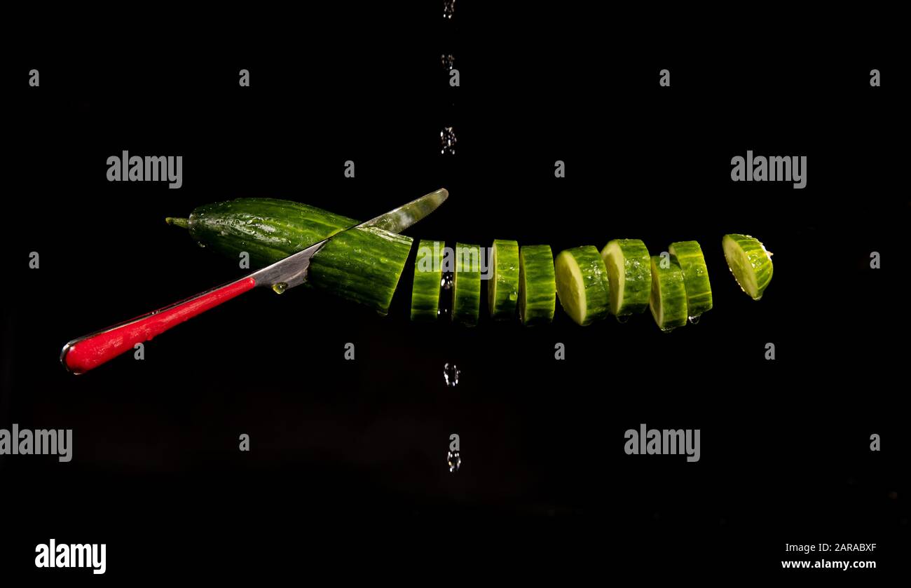 Sliced cucumber with splashing water or explosion flying in the air ...