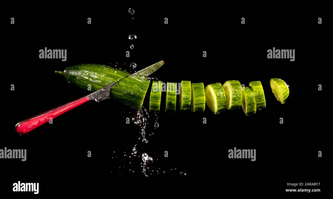 Sliced cucumber with splashing water or explosion flying in the air ...