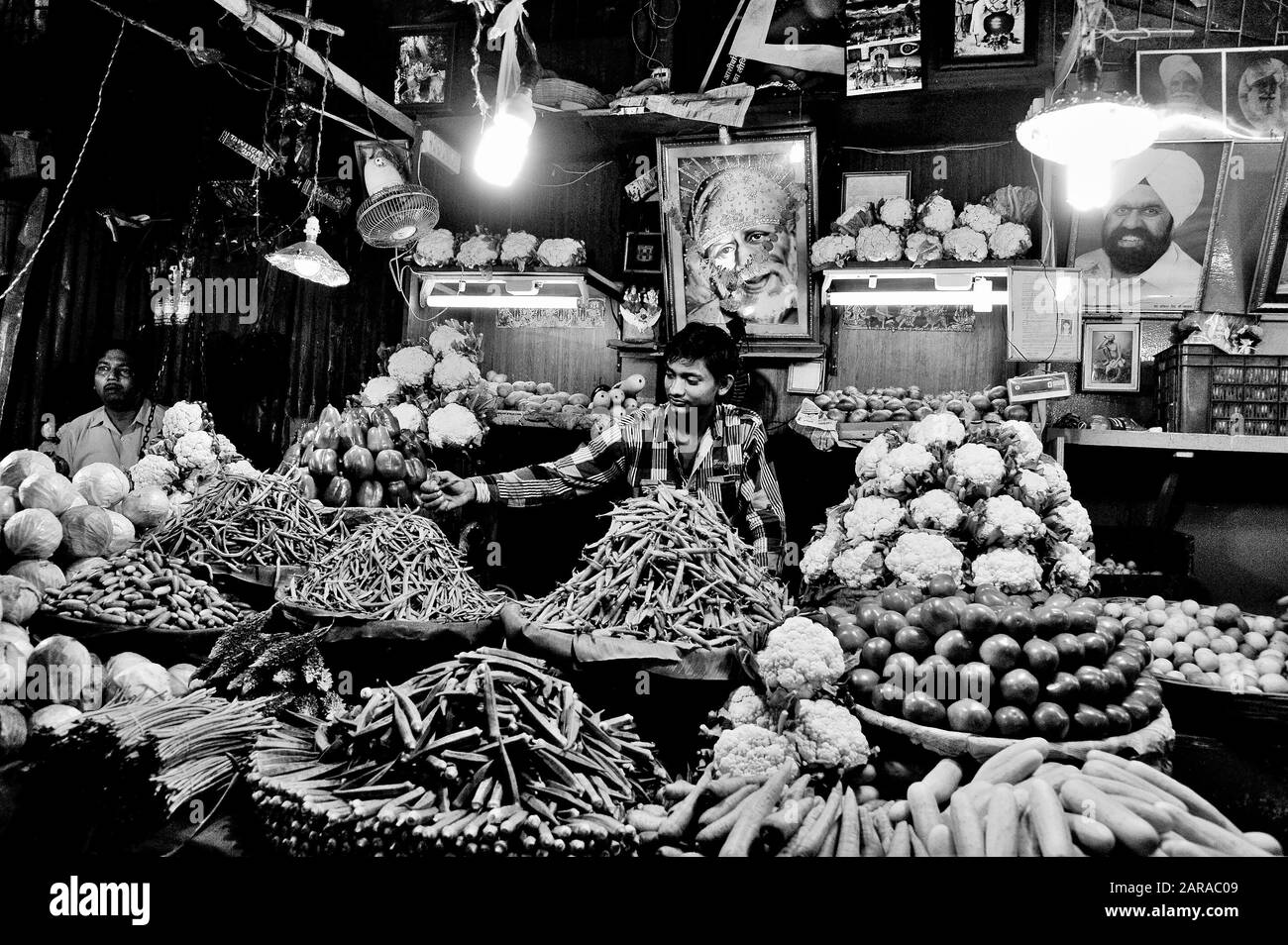 Vegetable vendor, God and man frames, Dadar, Mumbai, Maharashtra, India ...