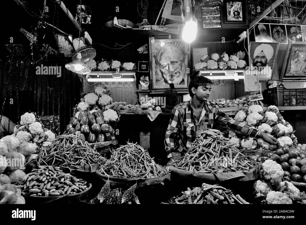 Vegetable vendor, God and man frames, Dadar, Mumbai, Maharashtra, India ...