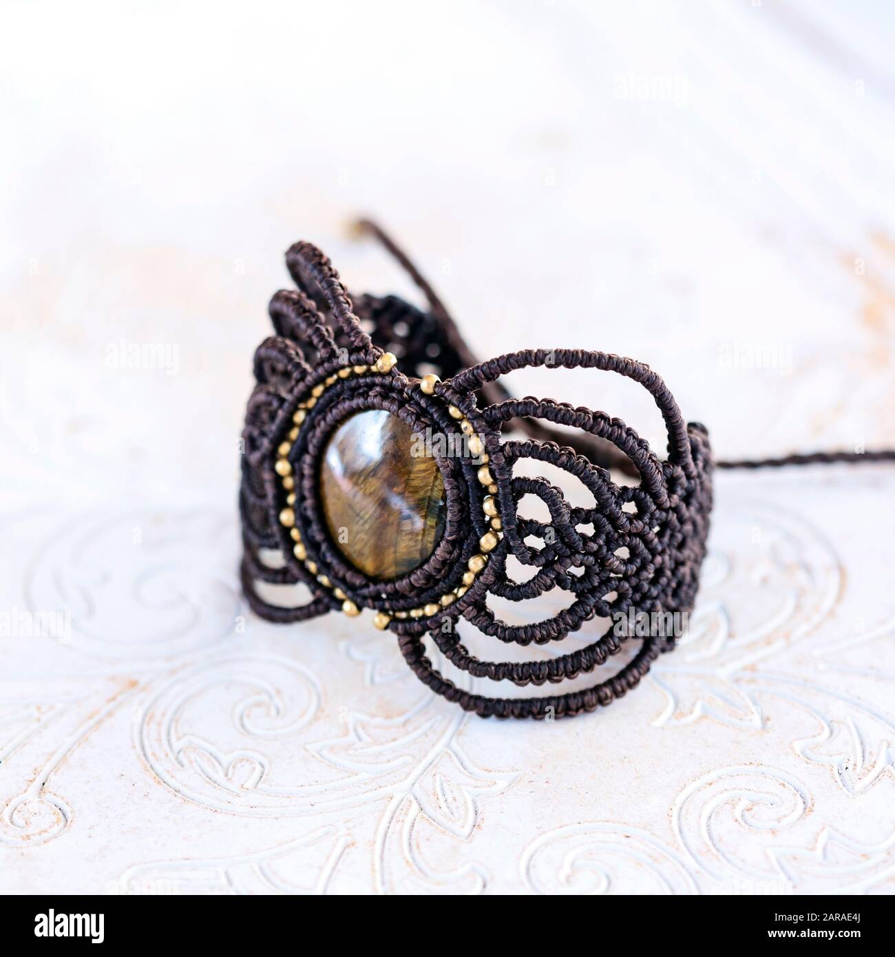 Stylish boho macrame string natural mineral stone bracelet on white ...