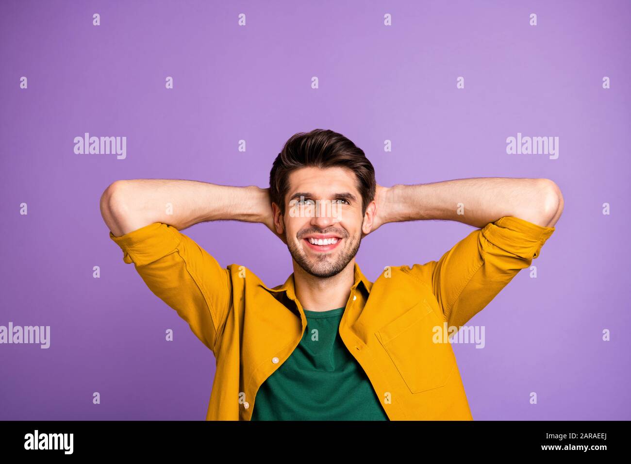 Photo of cheerful beaming attractive man with toothy smile looking up ...