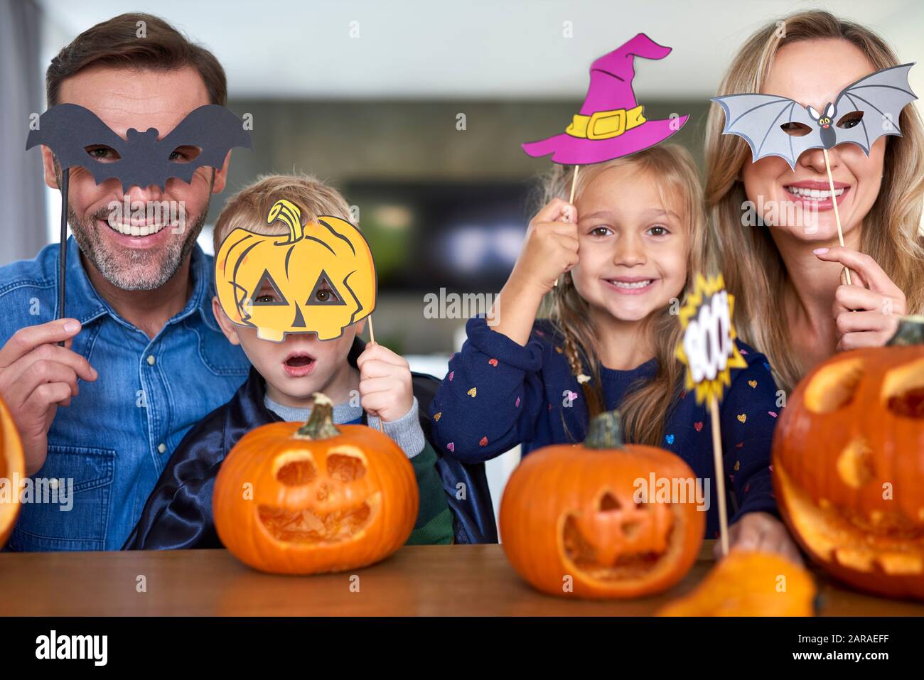 Portrait of happy family in Halloween masks Stock Photo - Alamy