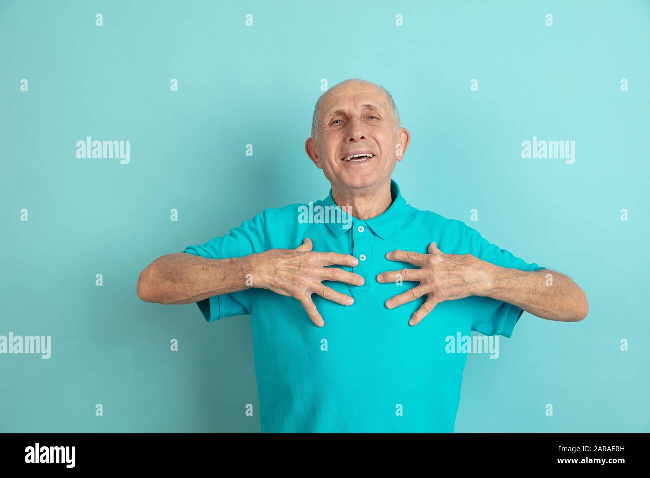 Pointing on himself. Caucasian senior man's portrait isolated on blue ...