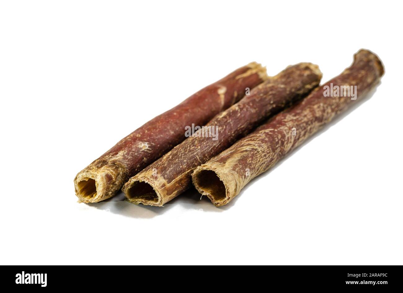 Three sticks of dried beef esophagus on a white background. Close-up of ...