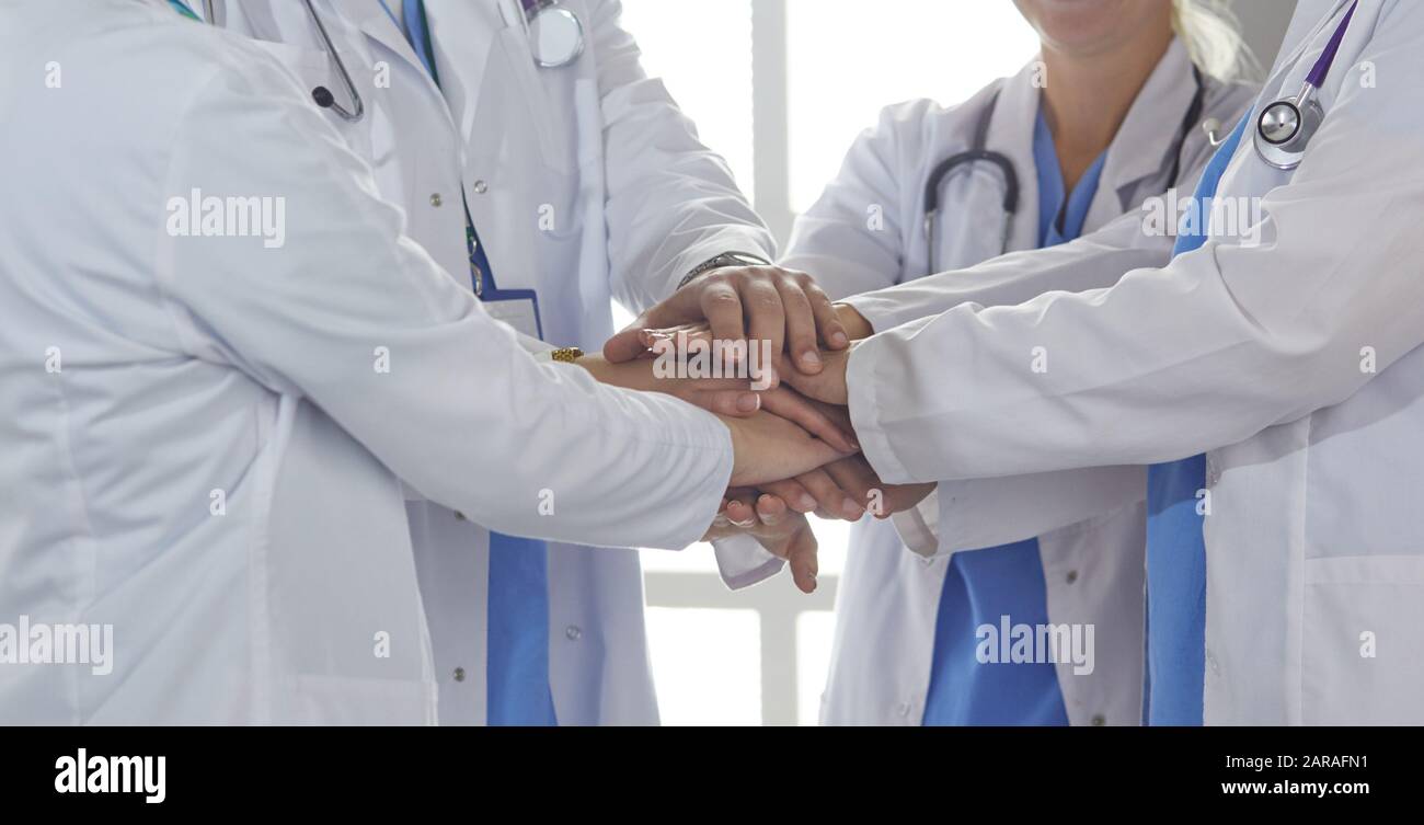 Team of medical workers holding hands together indoors, above view. Unity concept Stock Photo ...