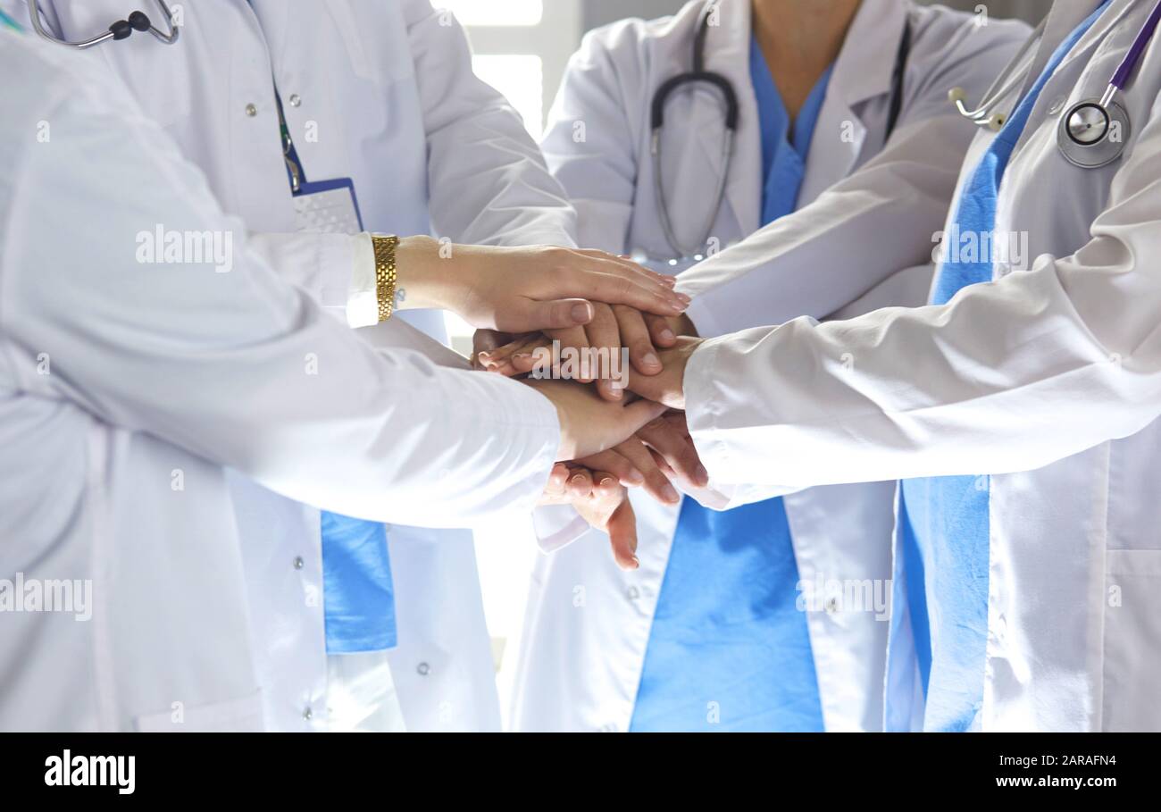 Team of medical workers holding hands together indoors, above view. Unity concept Stock Photo ...