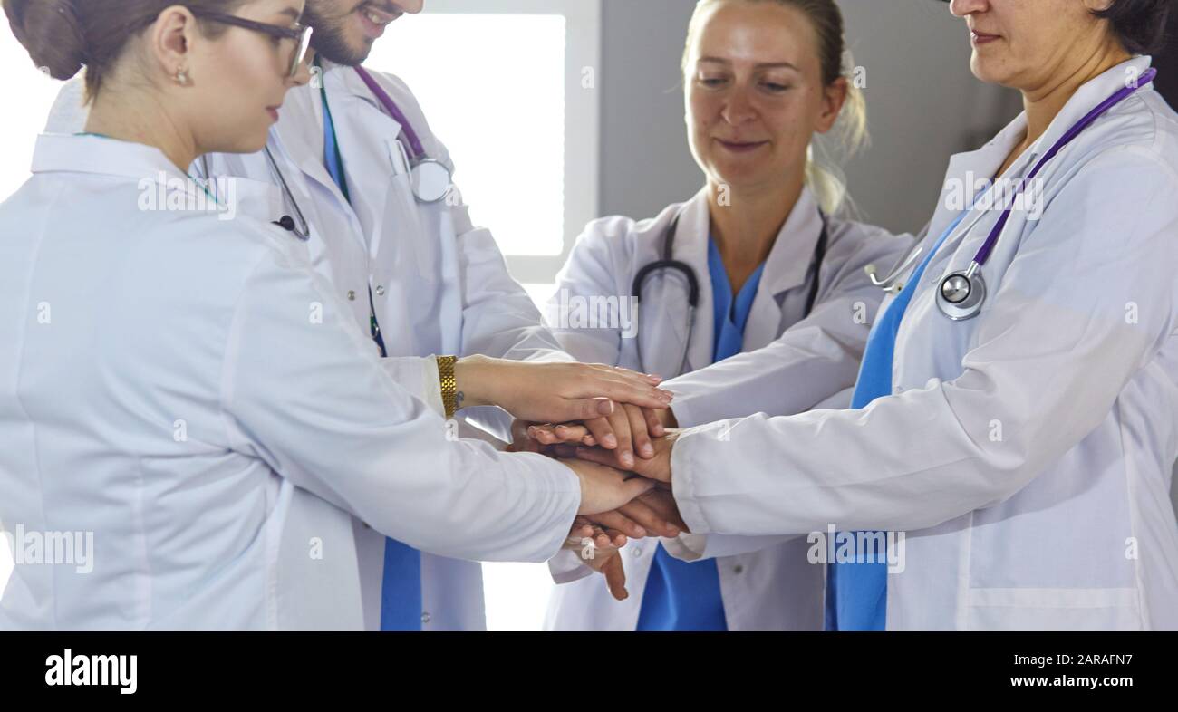 Team of medical workers holding hands together indoors, above view. Unity concept Stock Photo ...