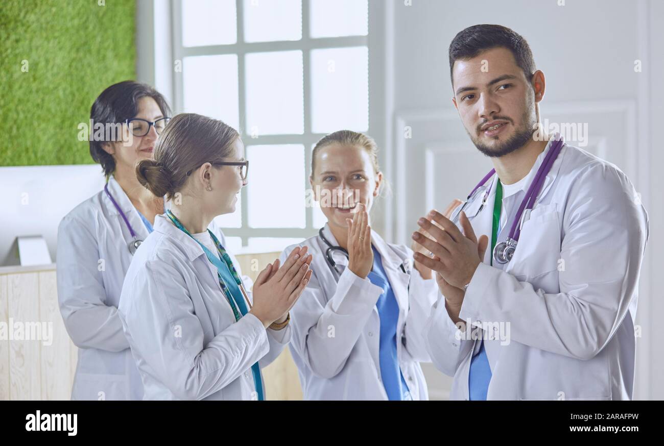 Happy medical team comprising male and female doctors smiling broadly ...