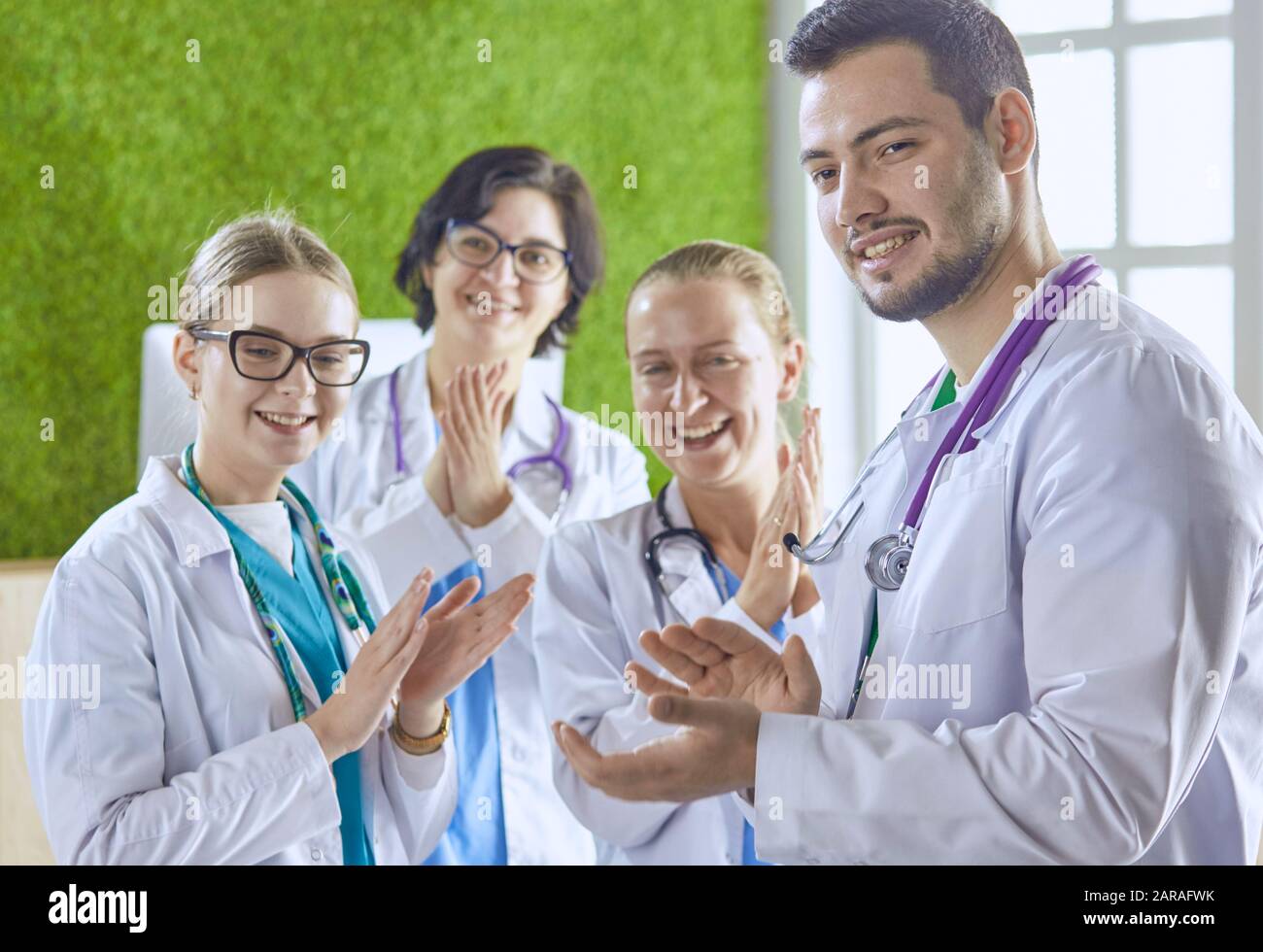 Happy medical team comprising male and female doctors smiling broadly ...