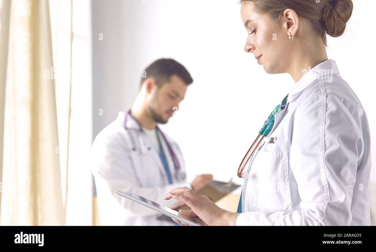 Patient with a group of doctors at the background Stock Photo - Alamy