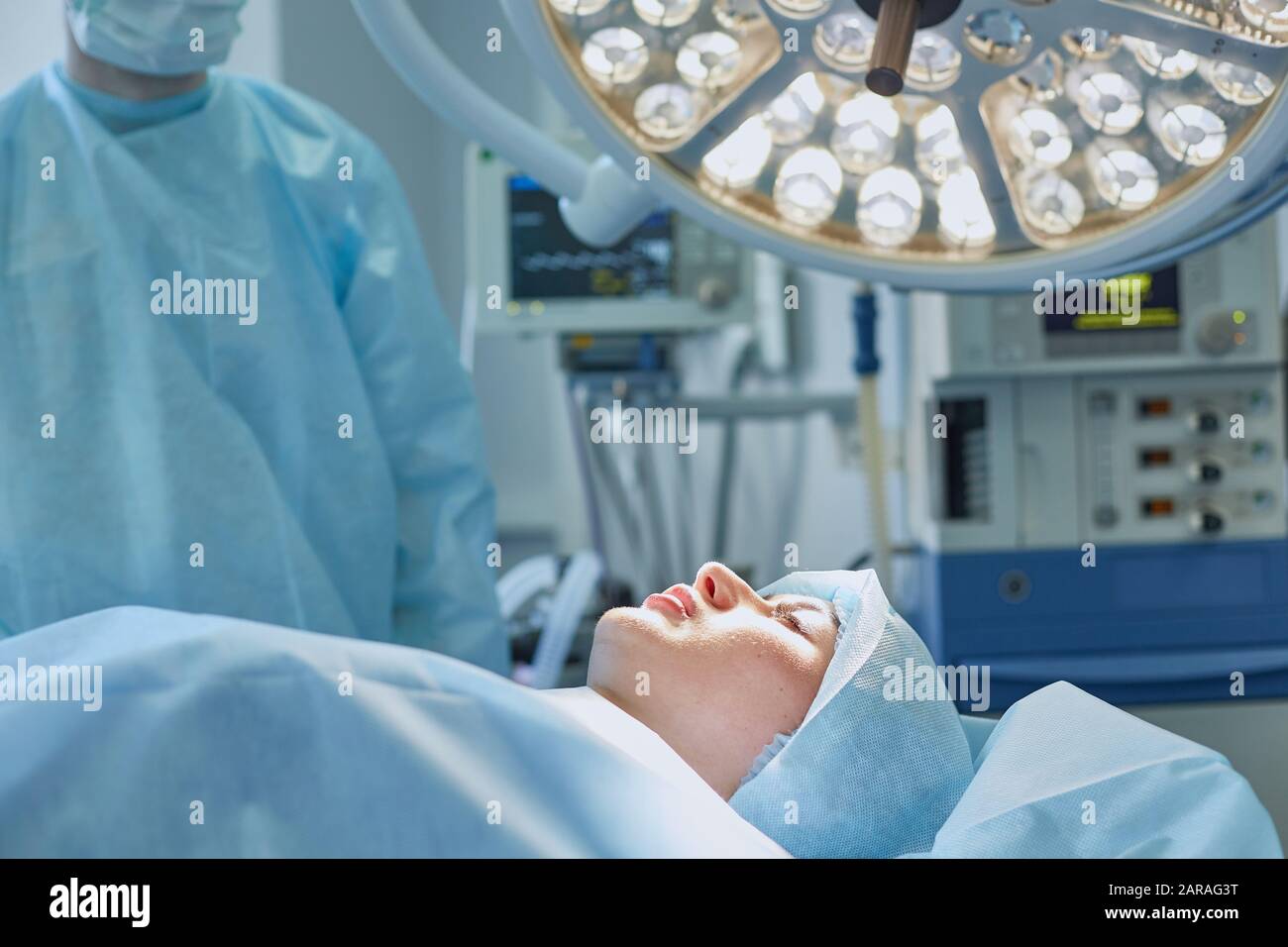 Several doctors surrounding patient on operation table during their ...