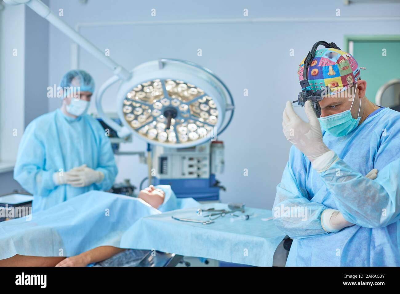 Several doctors surrounding patient on operation table during their ...