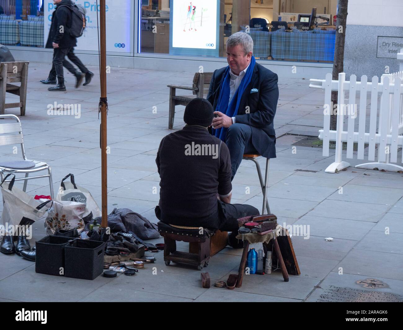 Shoe shine boy street trader cleaning shoes of businessman worker ...