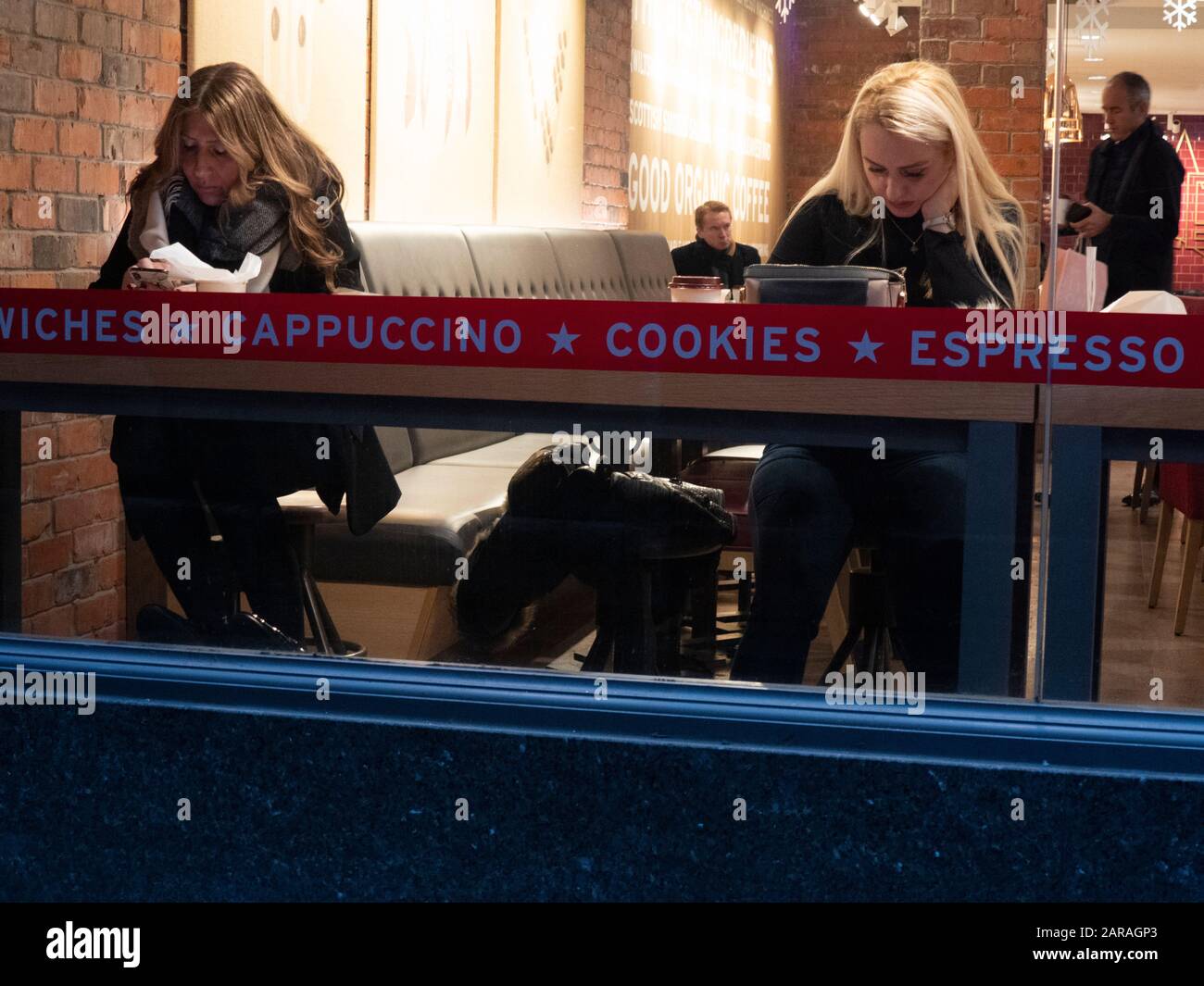 Pret a manger branch with customer in window looking at mobile phones ...