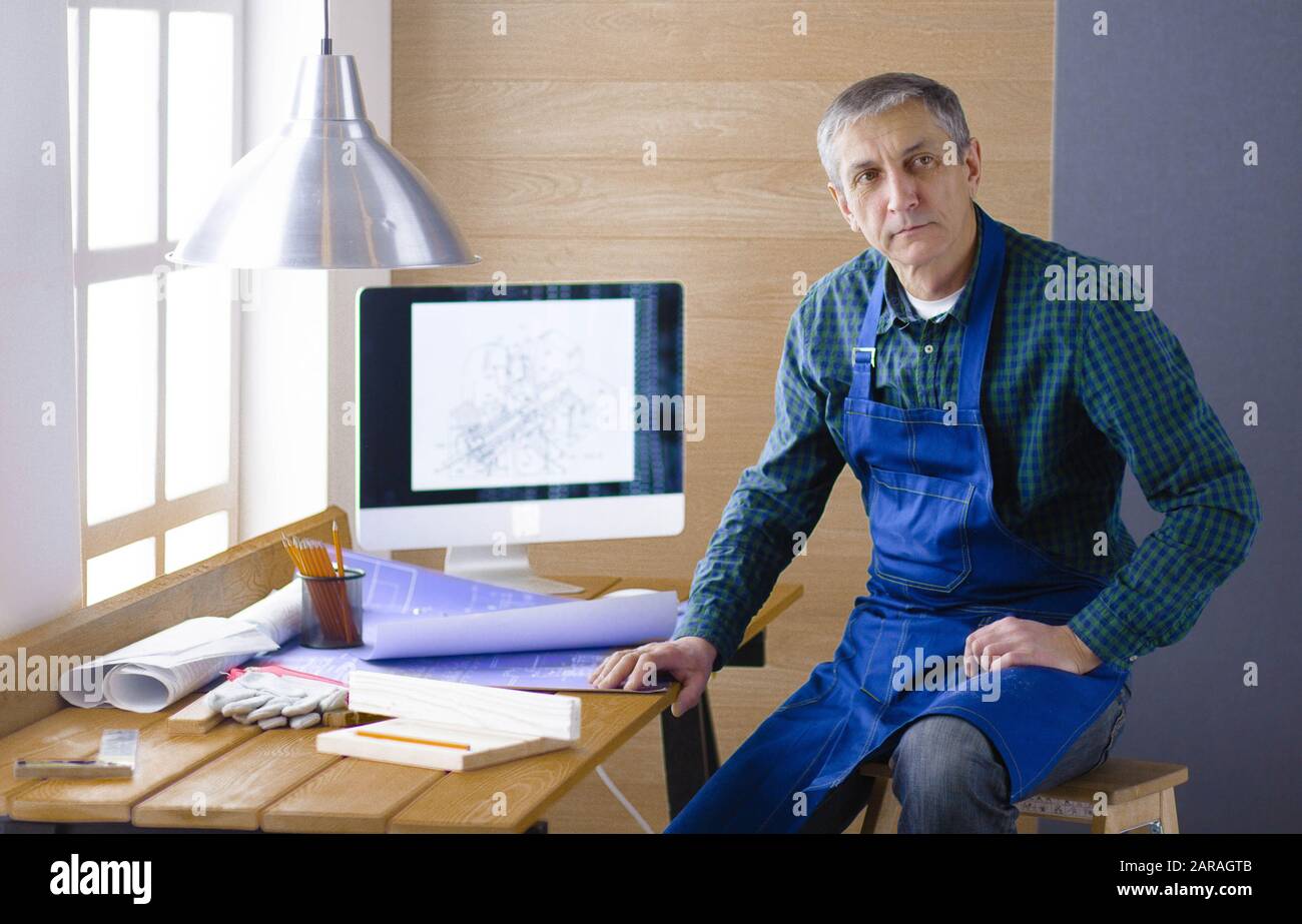 Engineer carpenter working on laptop and sketching project Stock Photo ...