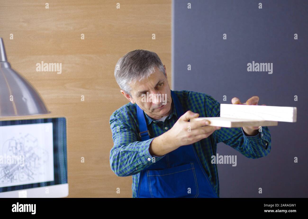 profession, carpentry, woodwork and people concept - carpenter testing ...