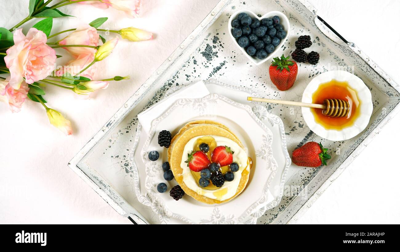 Pancake breakfast tray on table with syrup and blueberries fruit ...