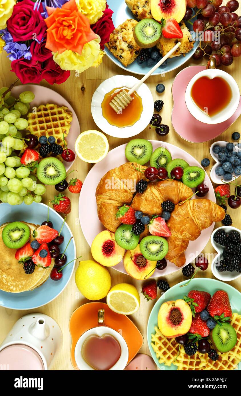 Indulgent breakfast creative layout flat lay with croissants, pancakes ...
