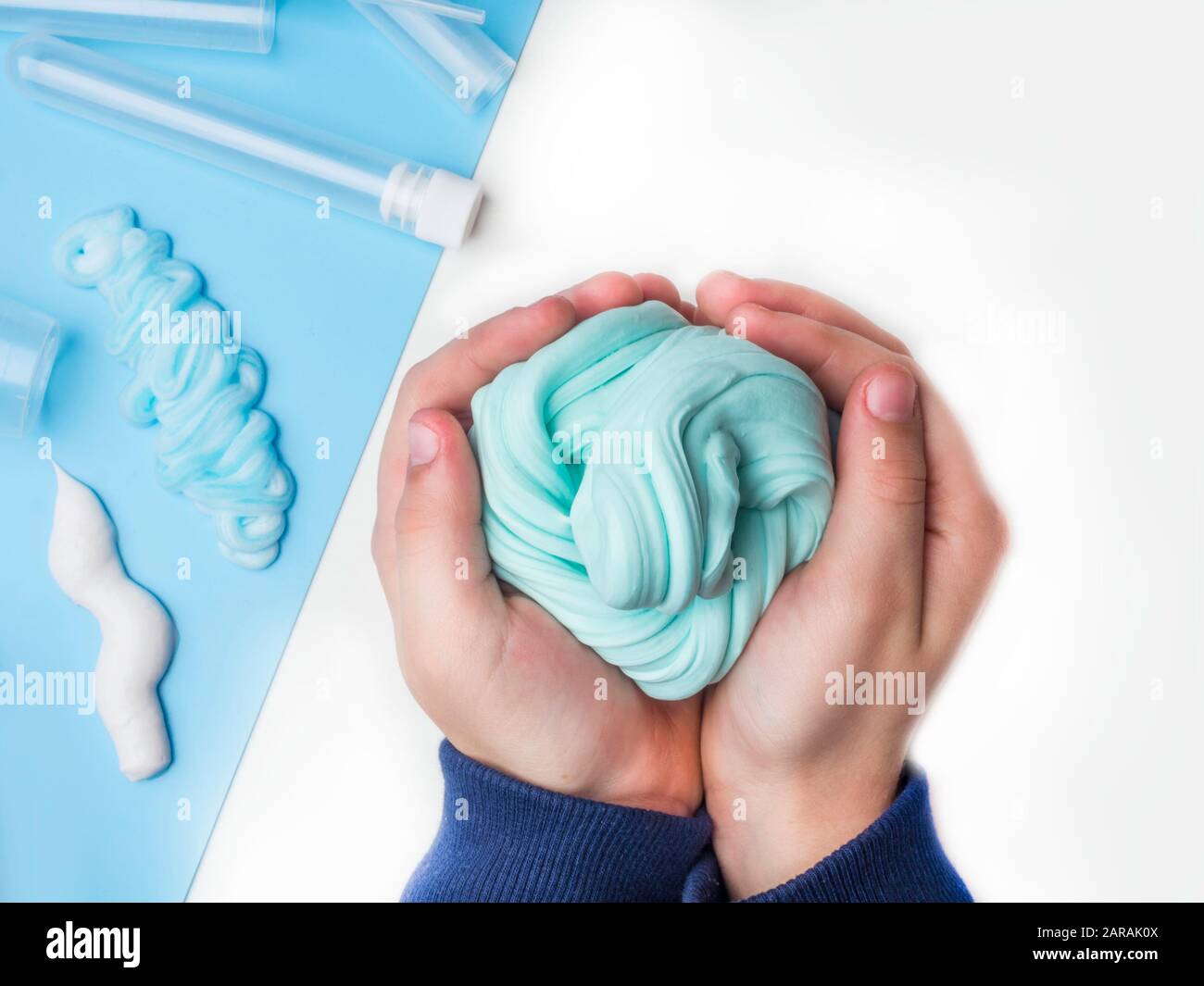 baby holding in hand blue slime and playing, children hobby, child ...