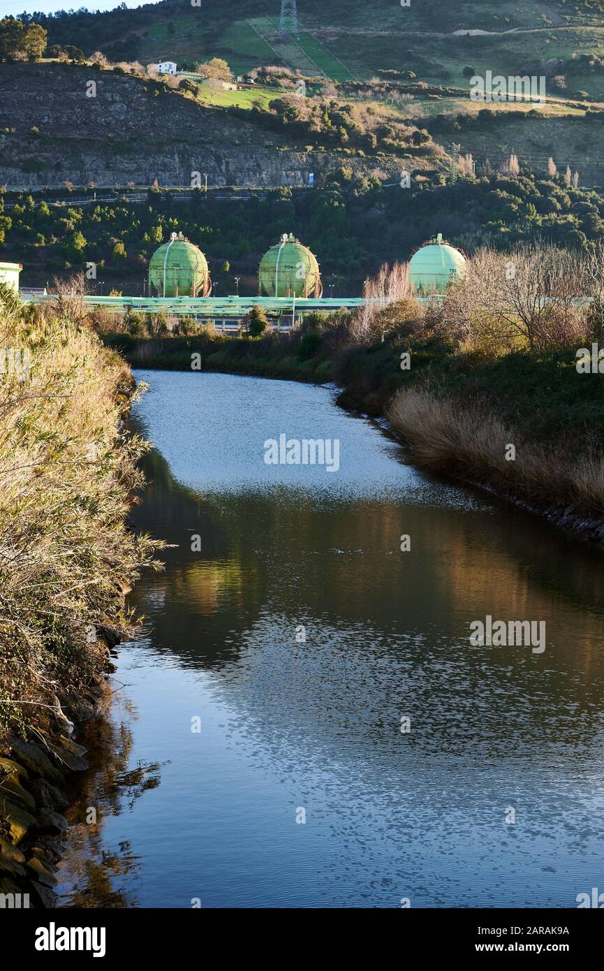 Barbadun river and Gas Tanks of Petronor, Oil Refinery, San Julian de ...