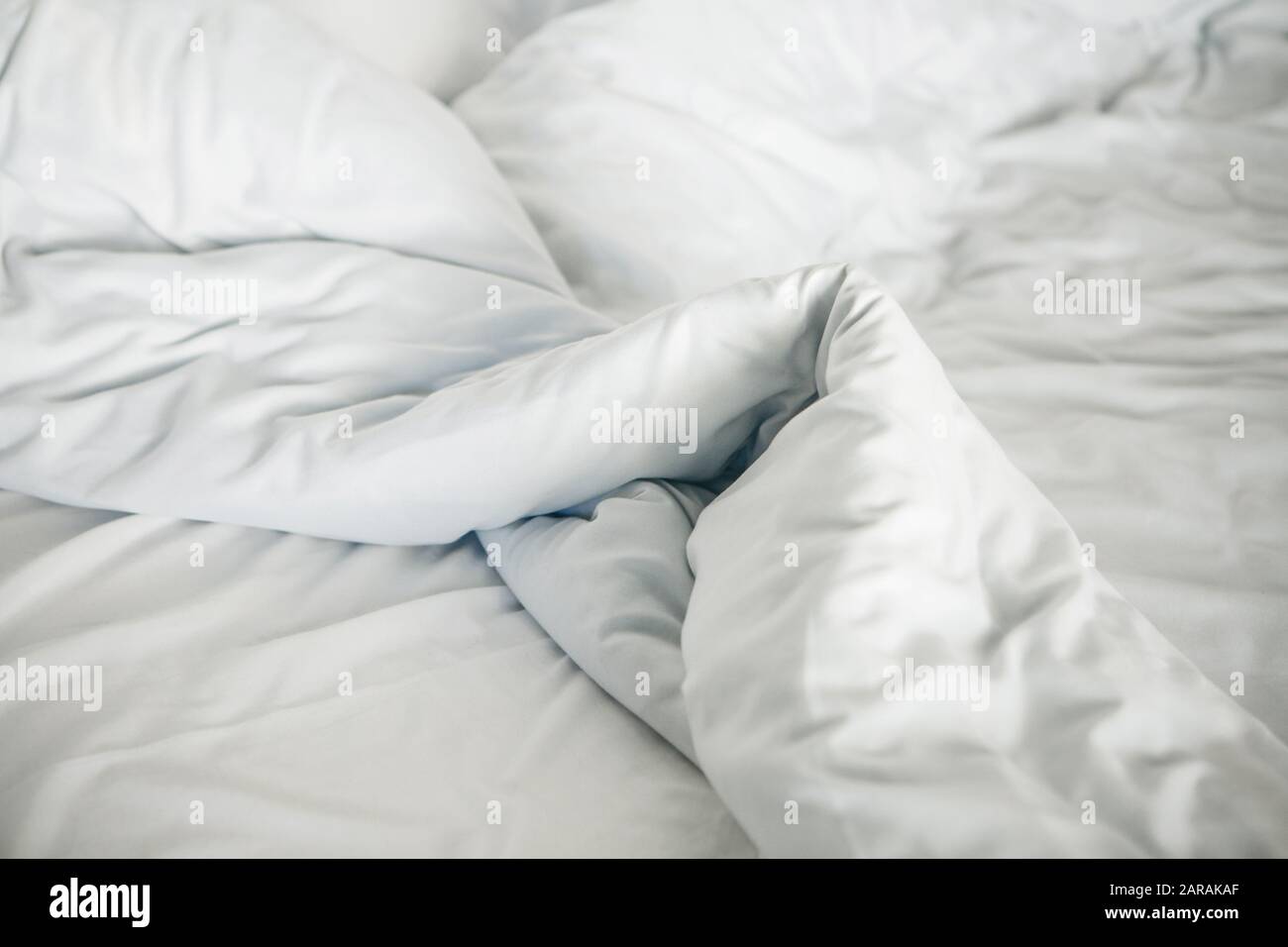 Crumpled white blanket on the bed after sleeping in the morning Stock ...