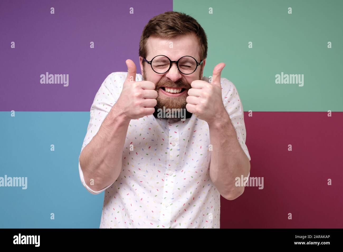Funny Bearded Man In Round Glasses Makes An Approving Gesture With