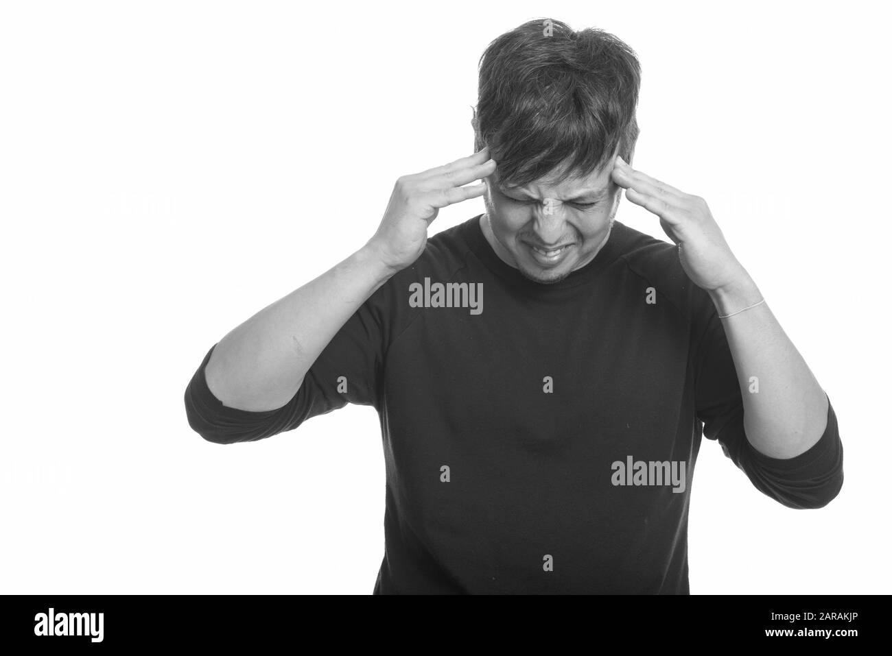 Studio shot of man with beard stubble isolated against white background ...
