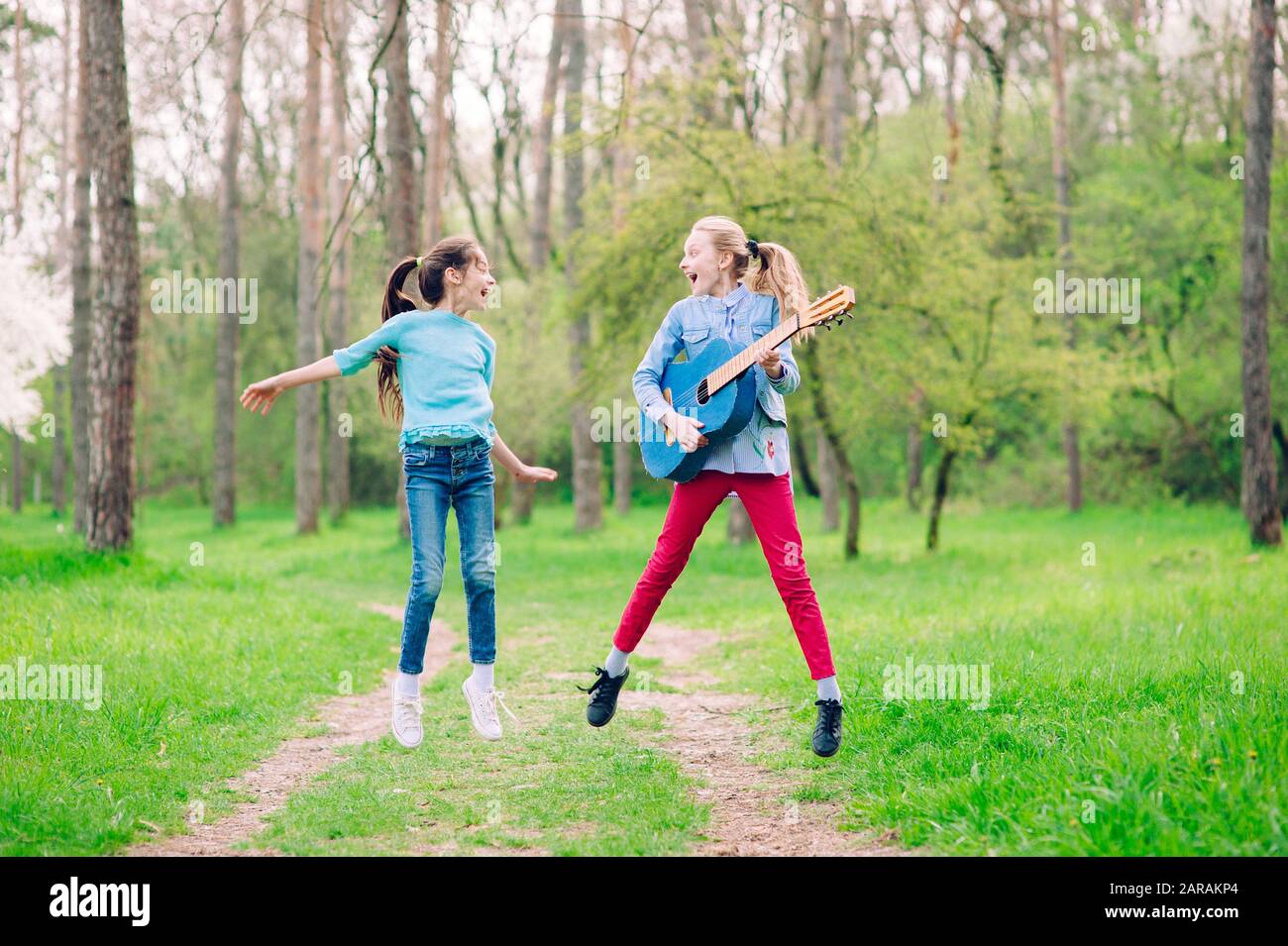 Children Jumping In Air In Park High Resolution Stock Photography and ...
