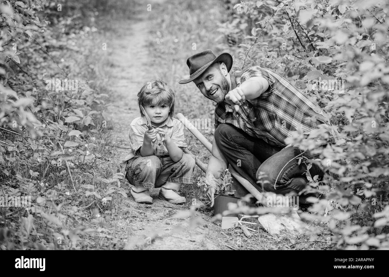 Day of earth. Boy and father in nature. Gardening tools. Planting ...