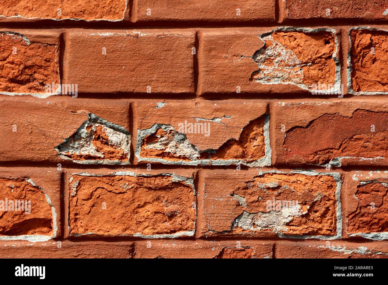 Cracked old dilapidated broken painted red brick suburban family house wall texture background ...