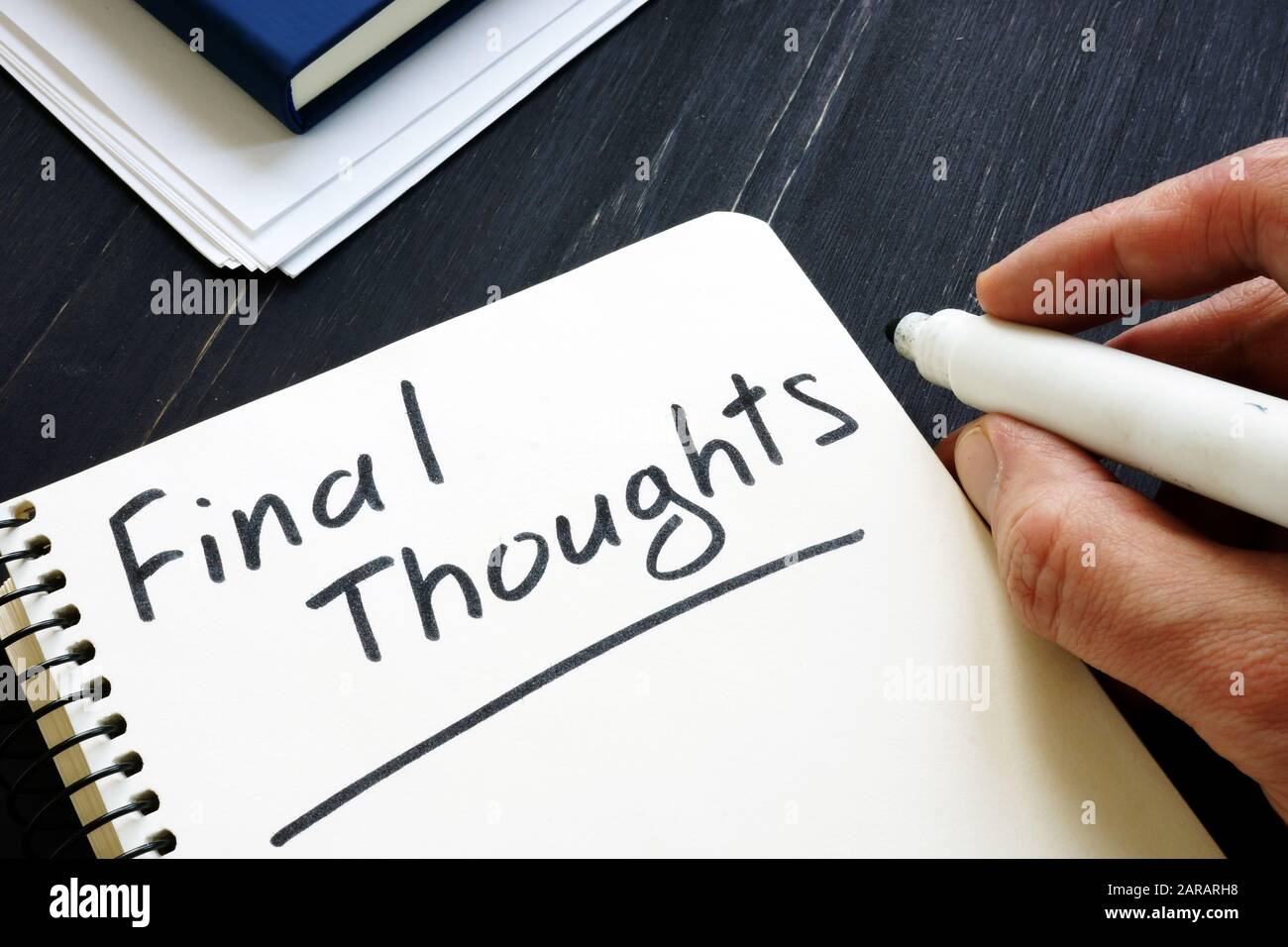 Man is writing Final Thoughts on the sheet Stock Photo - Alamy