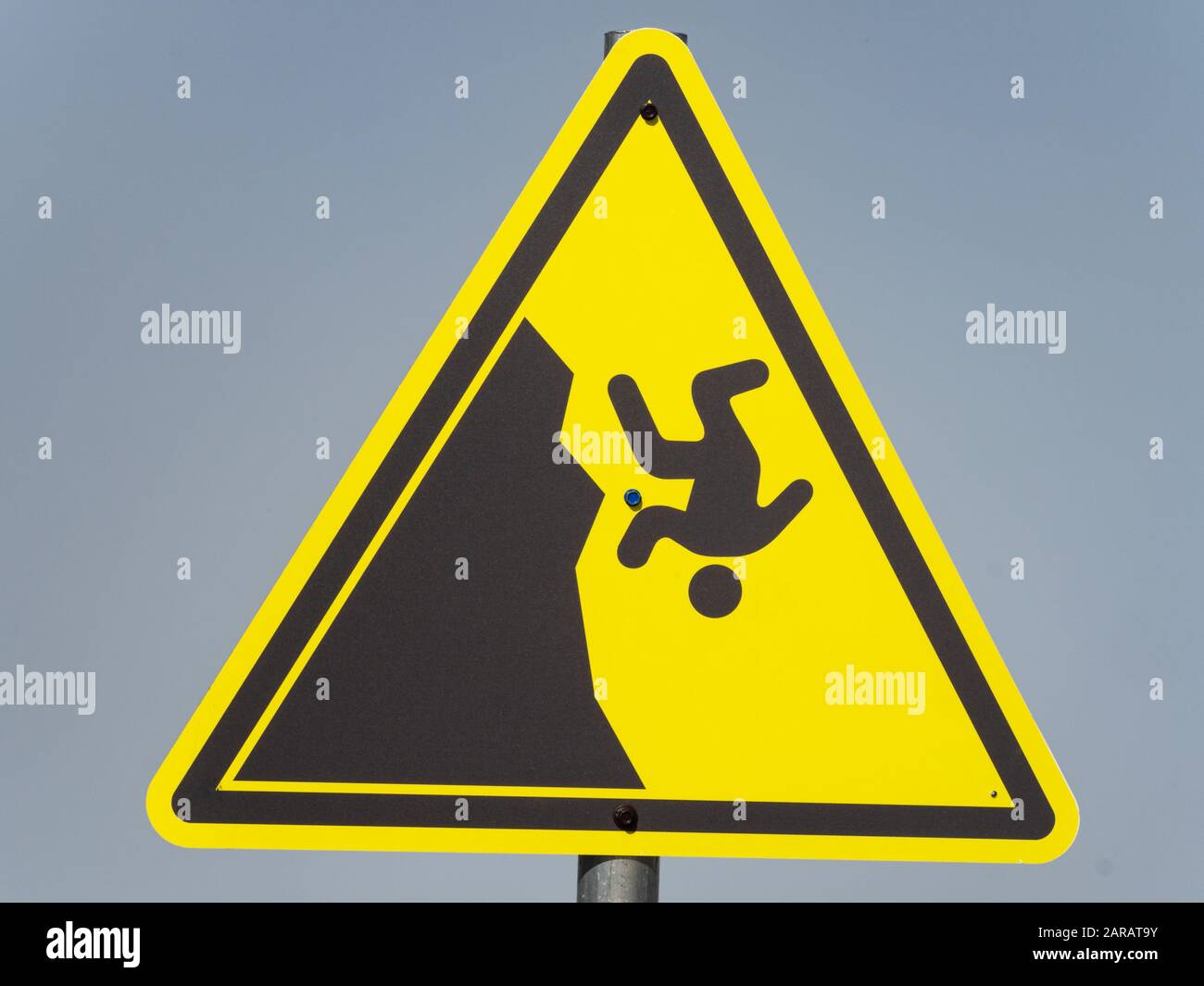 Yellow triangular hazard warning sign on gray background Stock Photo ...