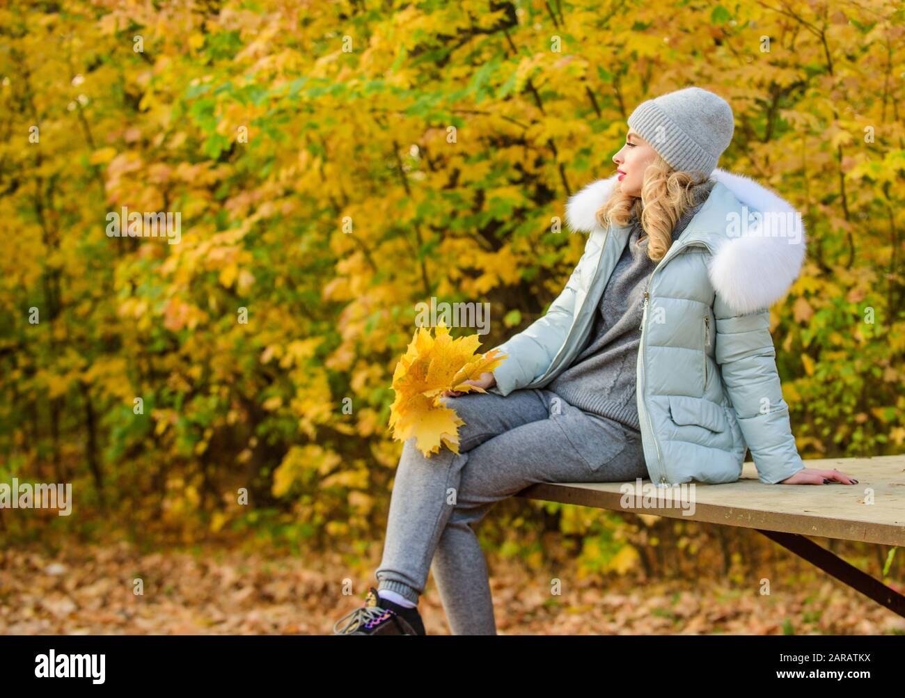 Feel practicality and comfort. Woman enjoy autumn season in park. Warm ...