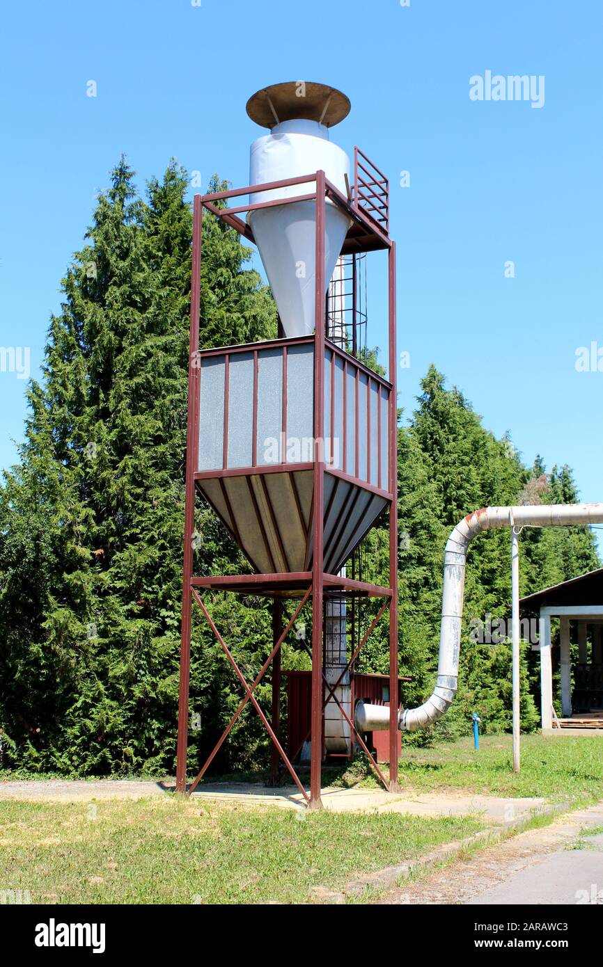 Renovated restored small unusually shaped metal storage silo supported ...