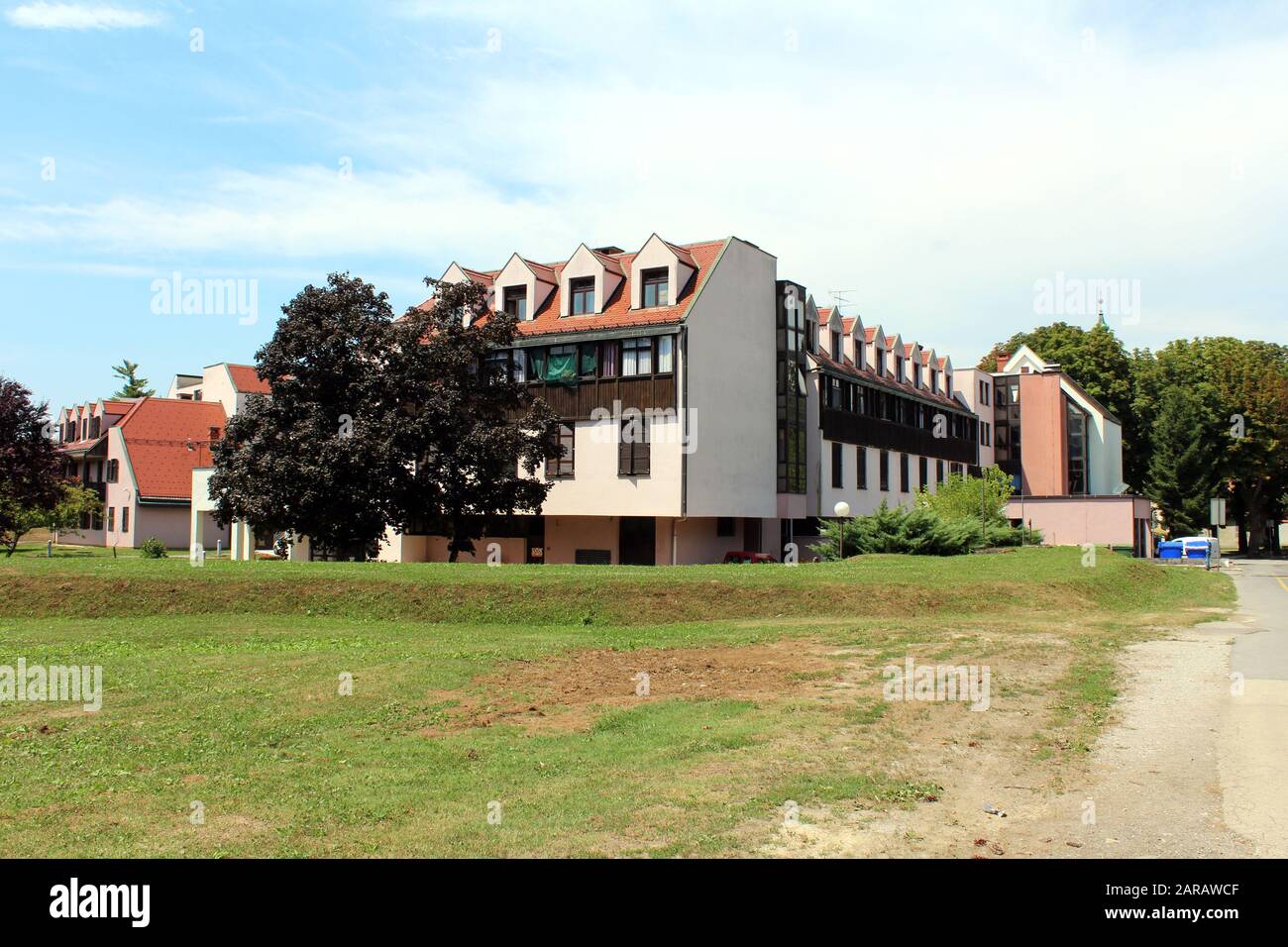 Renovated retirement home or old peoples home building with faded pink ...