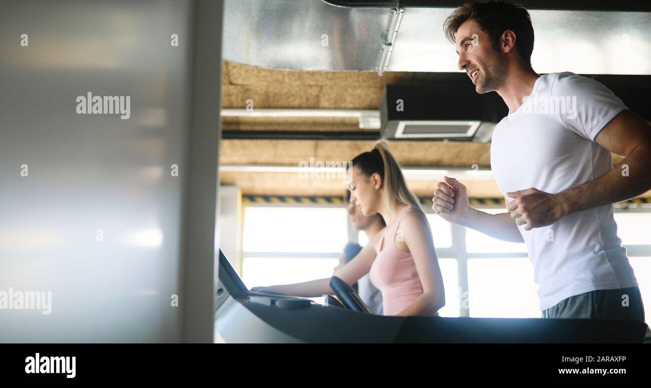 Group of people exercising in a gym cardio training and running Stock ...