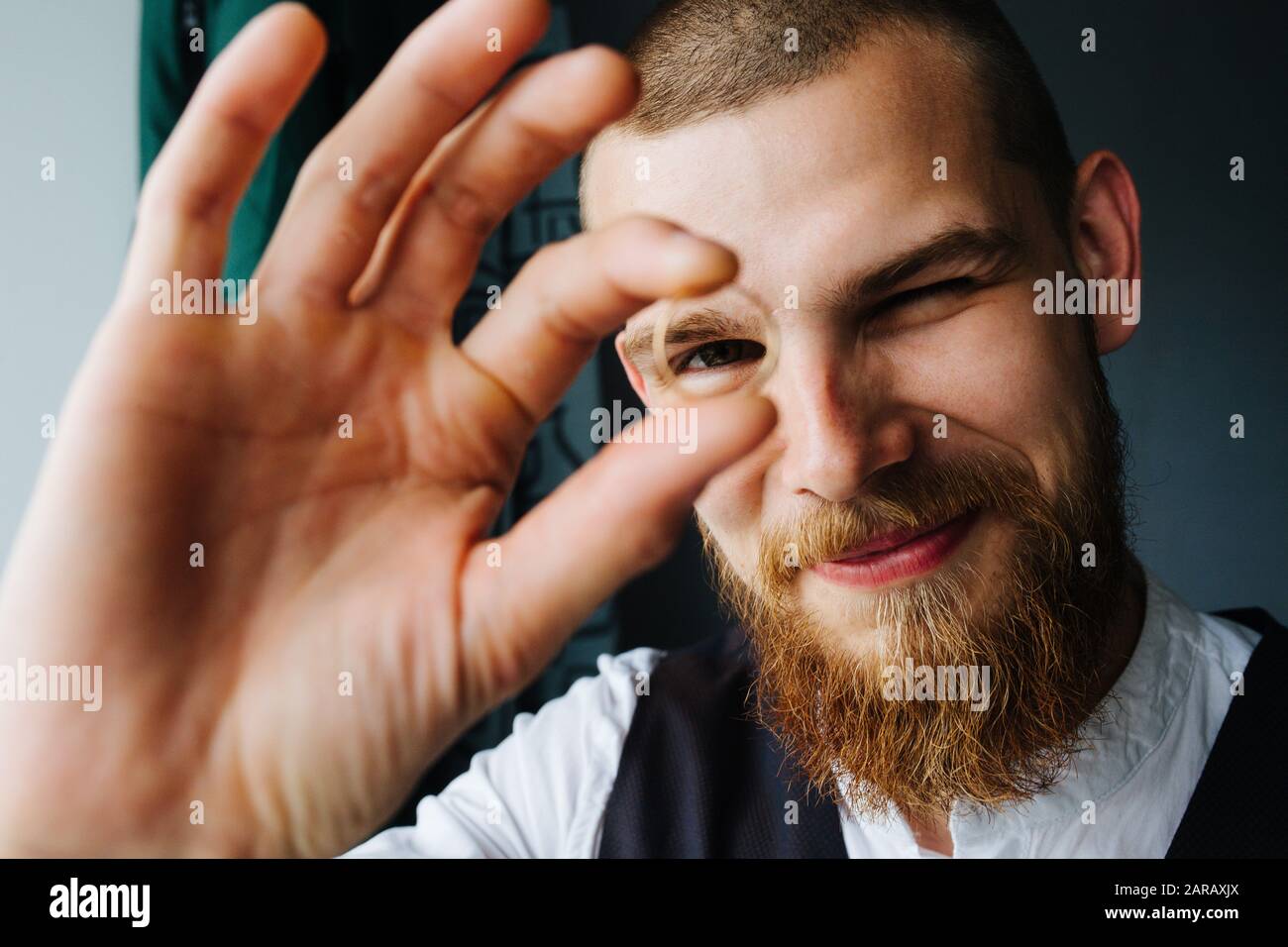Smiling groom looking through a ring before the marriage ceremony Stock ...