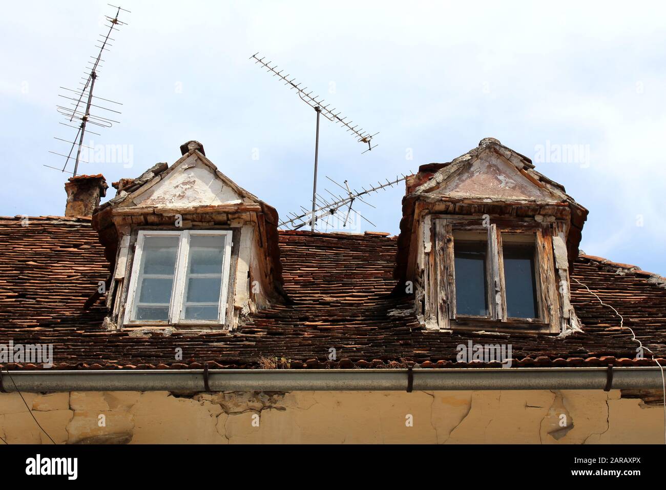 Two old destroyed roof windows with cracked wooden frames on top of ...