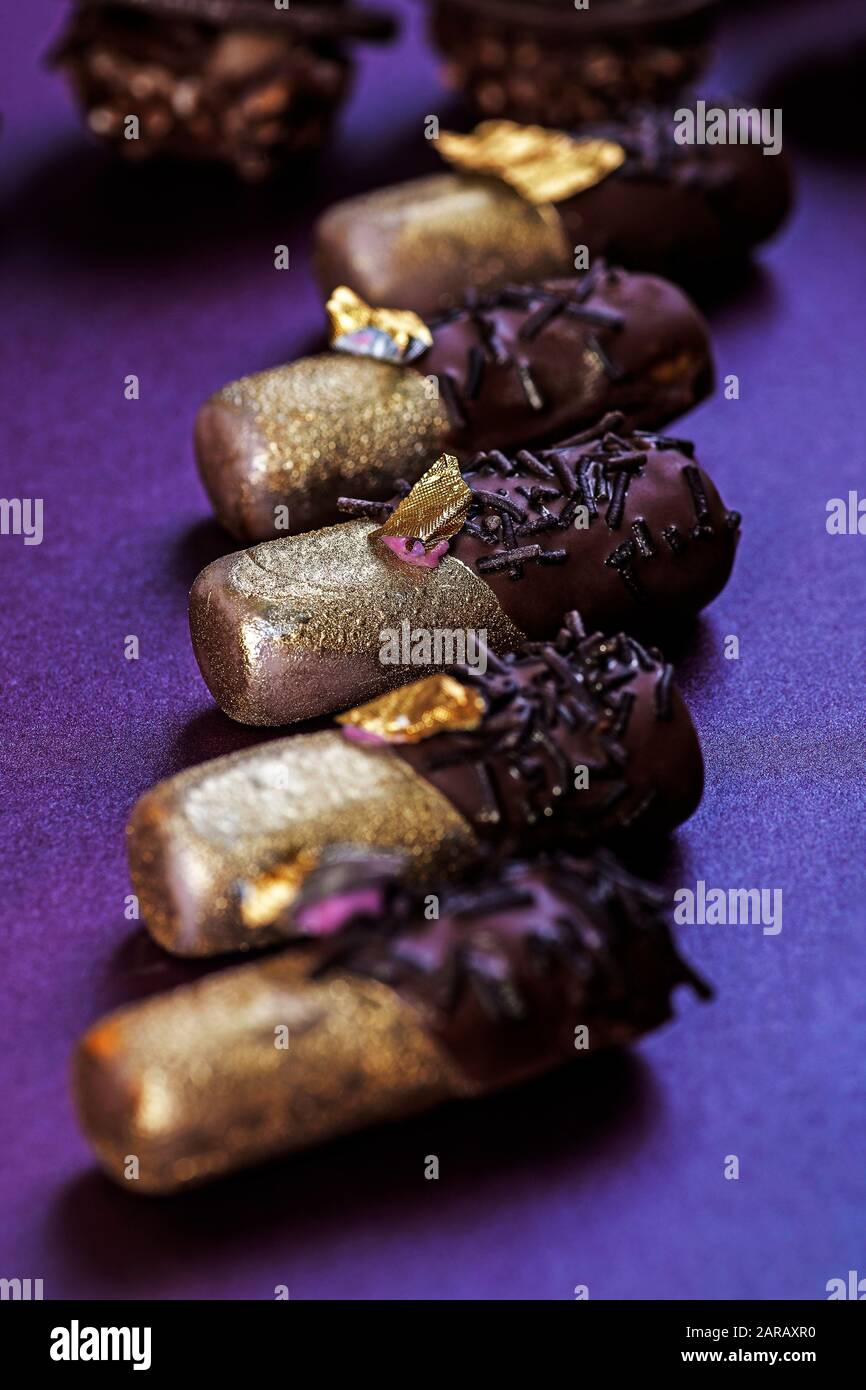Small chocolate sweets with hazelnut Stock Photo - Alamy
