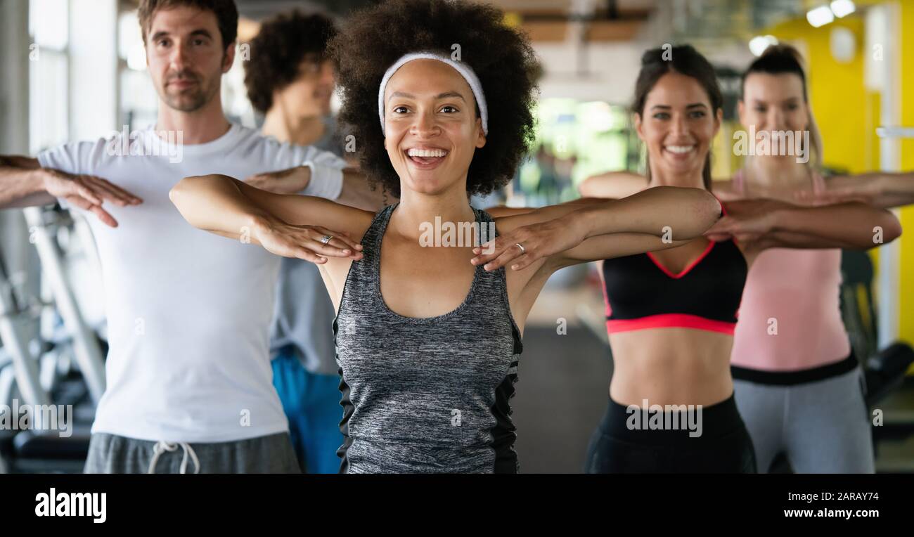 Group of healthy fit people at the gym exercising Stock Photo - Alamy