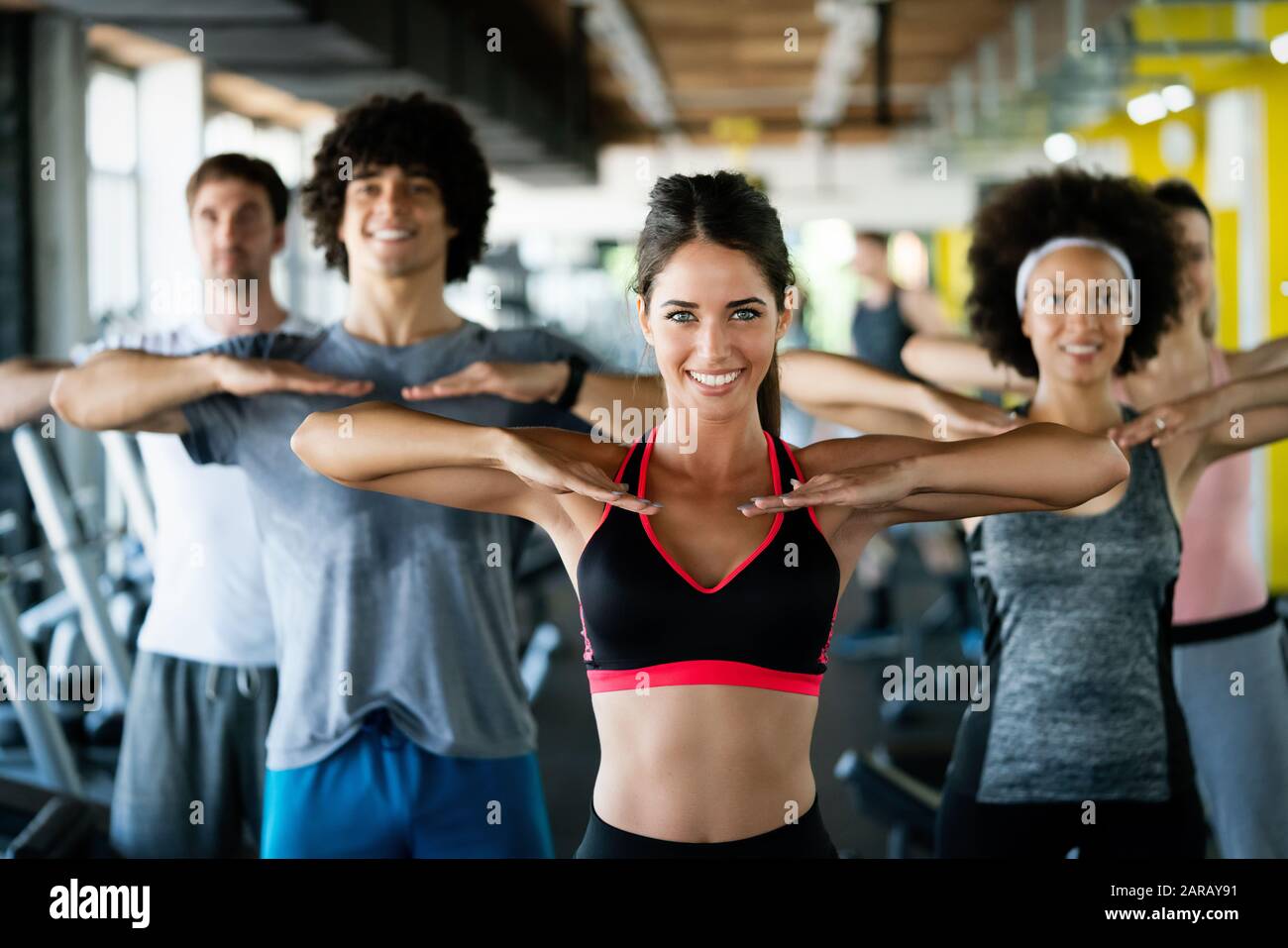 Group of happy multiracial friends exercising together in gym Stock ...