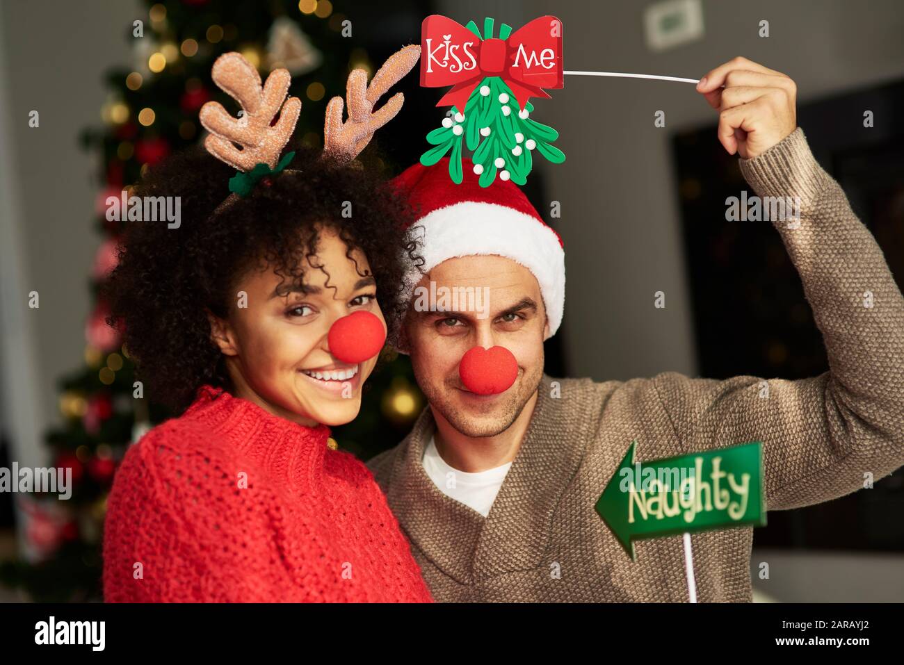 Kissing under the mistletoe portrait hi-res stock photography and ...