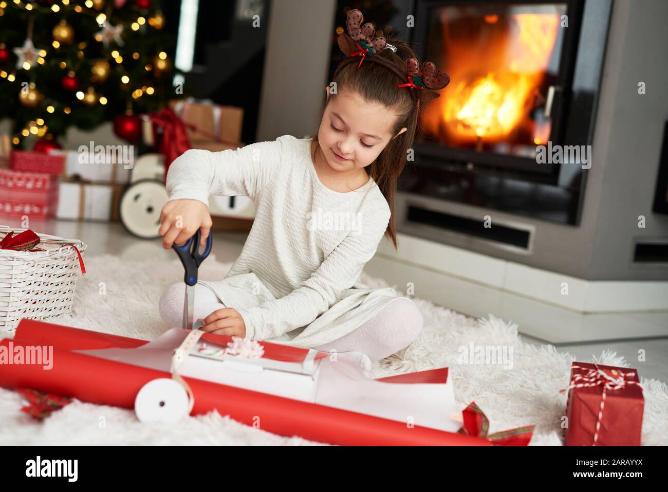 Little girl packing Christmas gifts Stock Photo - Alamy