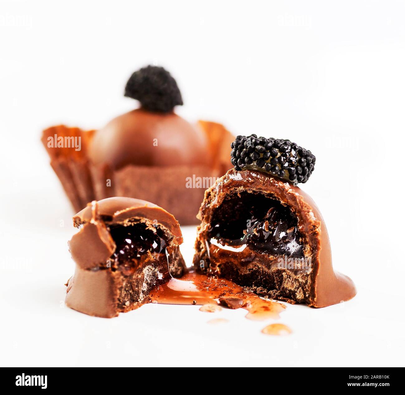 Cut handmade chocolate candy on white background Stock Photo - Alamy