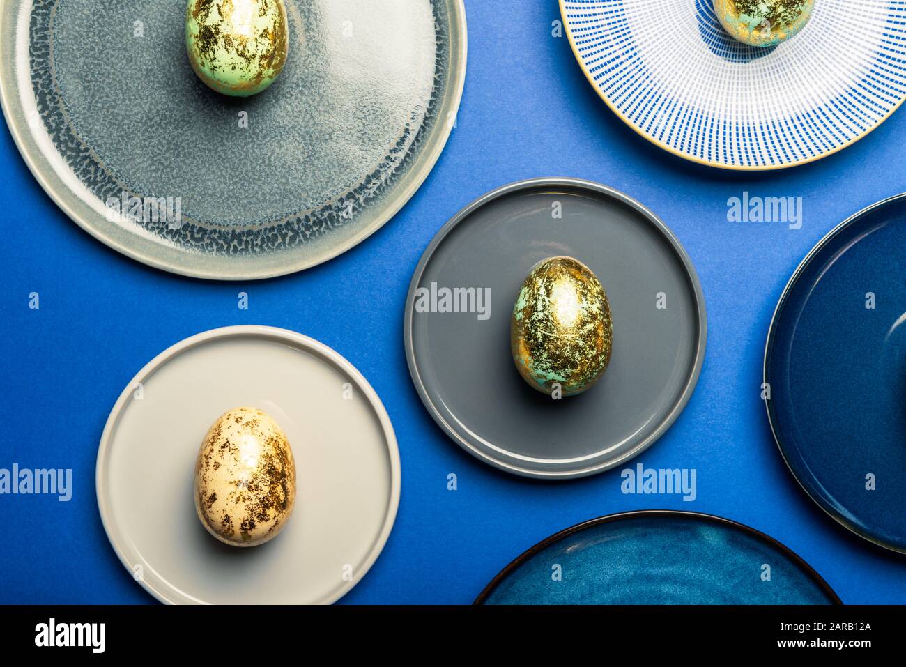 Different Ceramic Plates with Golden Speckled Easter Eggs of pastel ...