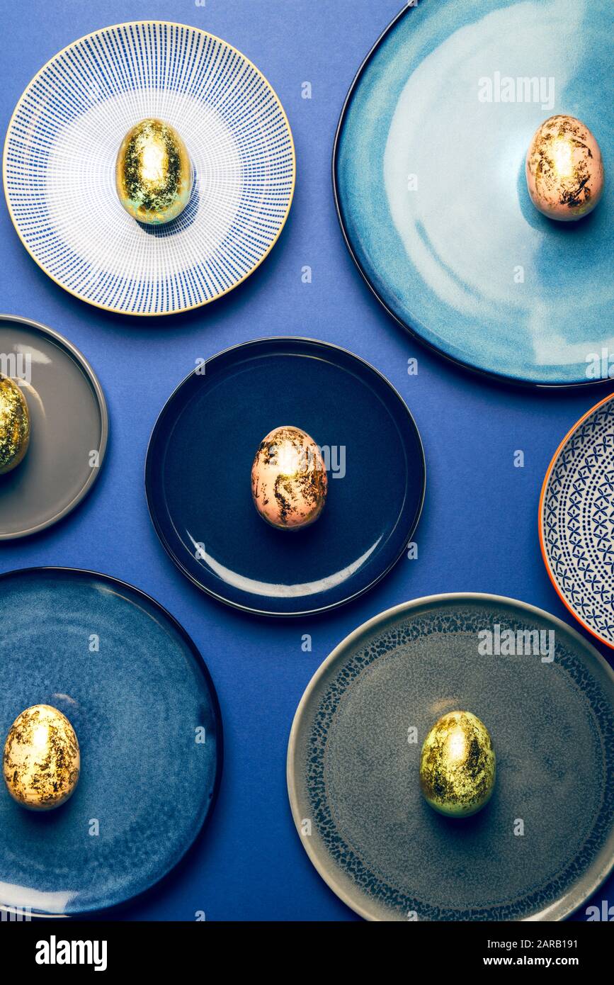 Different Ceramic Plates with Golden Speckled Easter Eggs of pastel ...